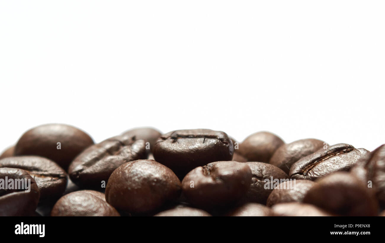 Coffee beans closeup isolated white background Stock Photo - Alamy