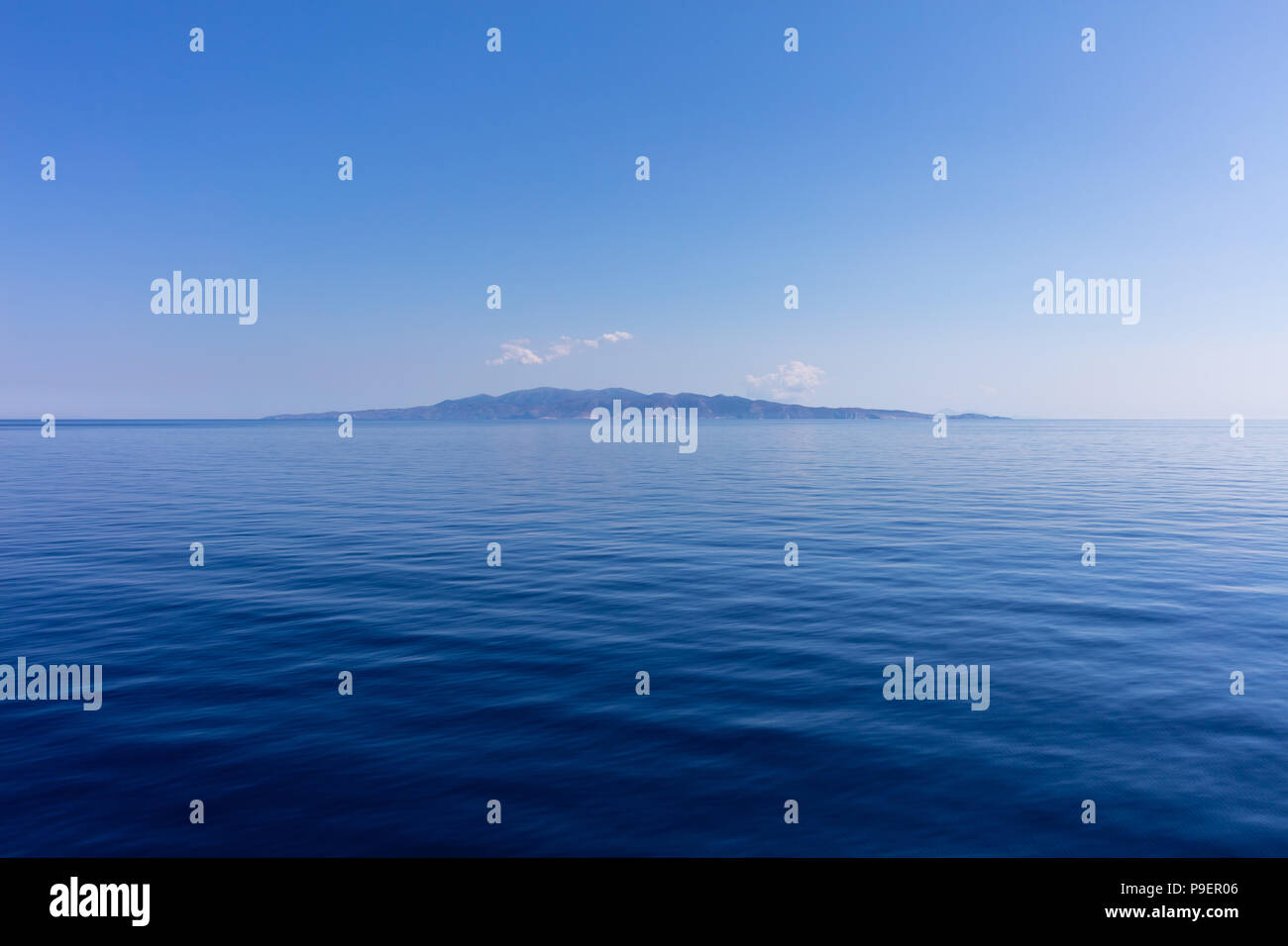 Greece. Aegean sea, Cyclades. Small cycladic island on blue sky and ...