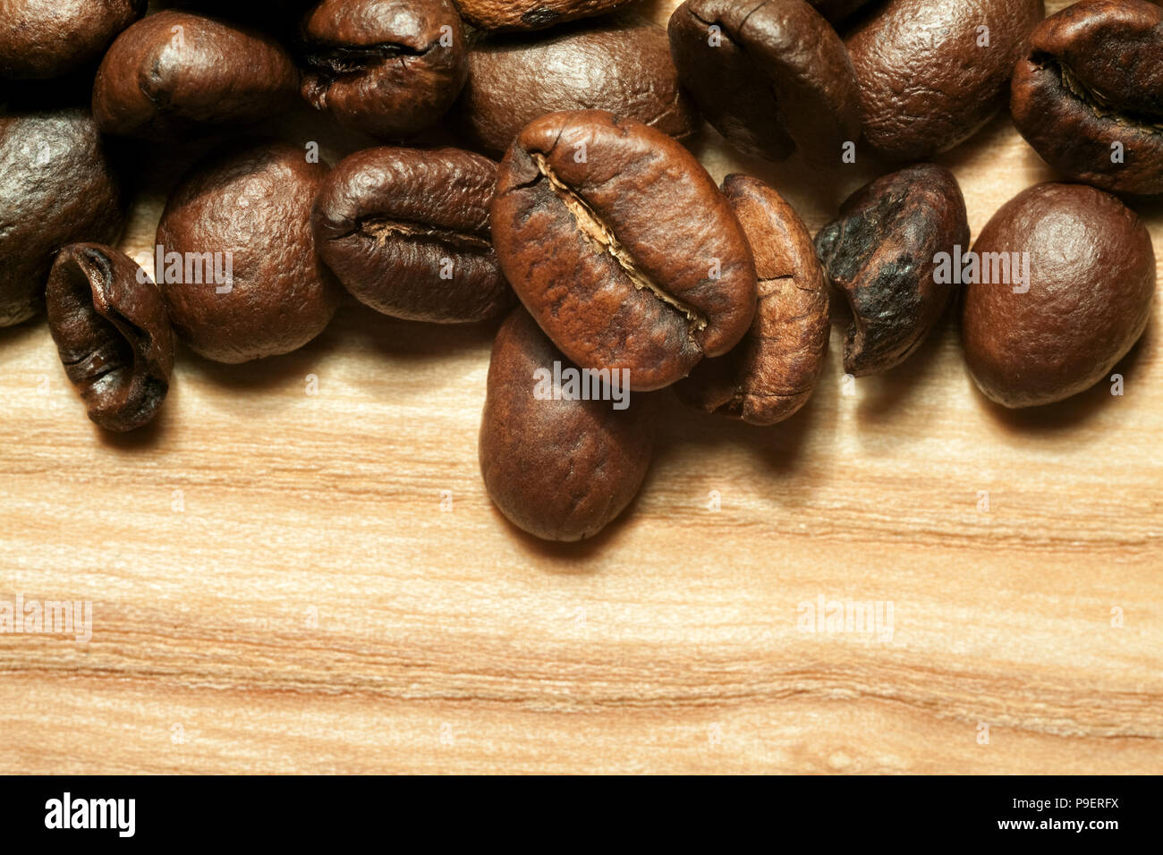 Coffee beans on beech tree background close-up Stock Photo - Alamy