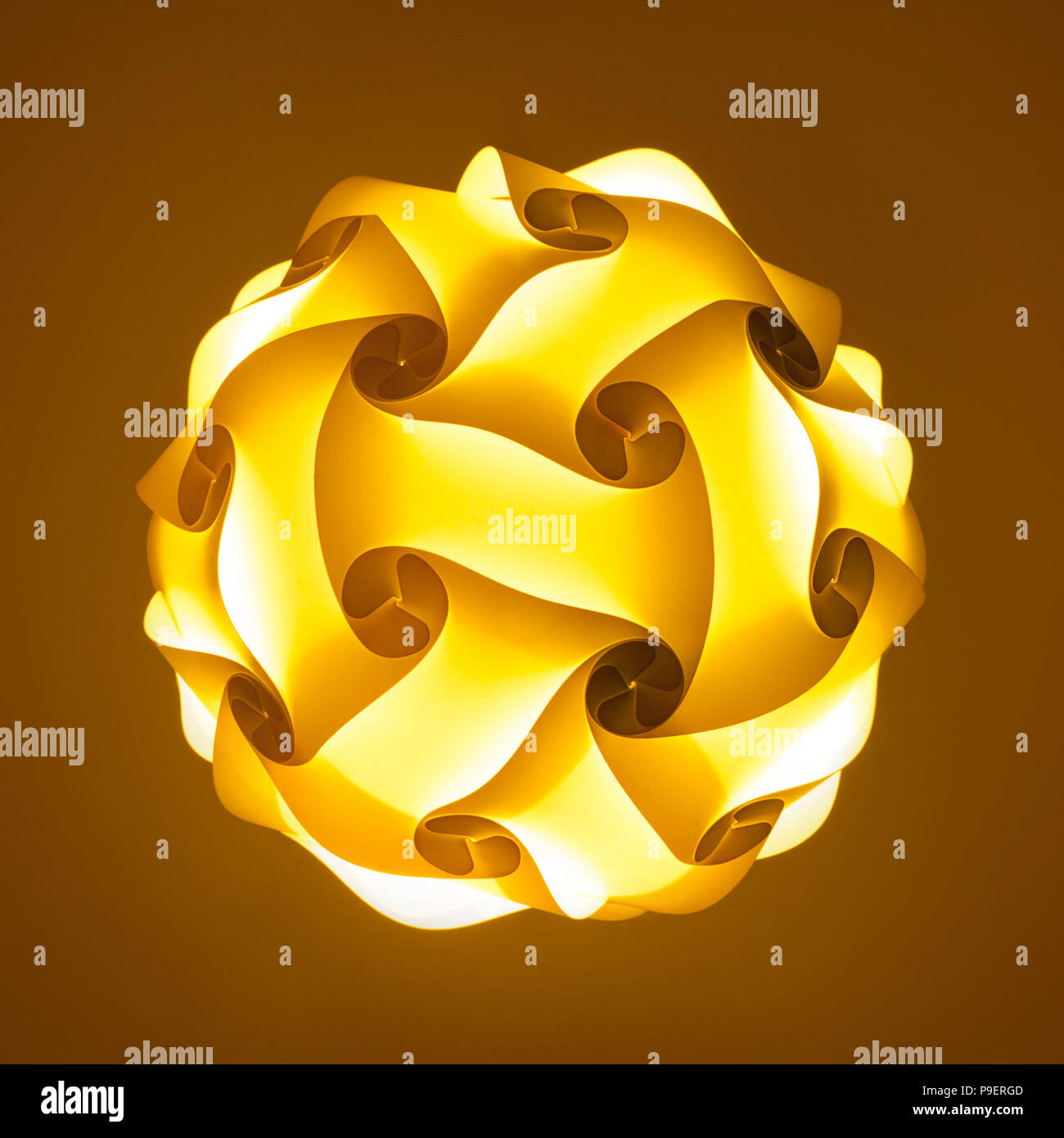 Glowing polygon lampshade. Geometric pattern. Golden light Stock Photo ...