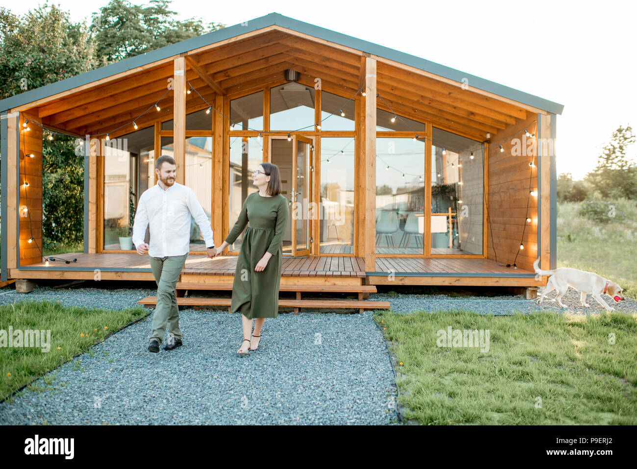 Walking dog couple house hi-res stock photography and images - Alamy