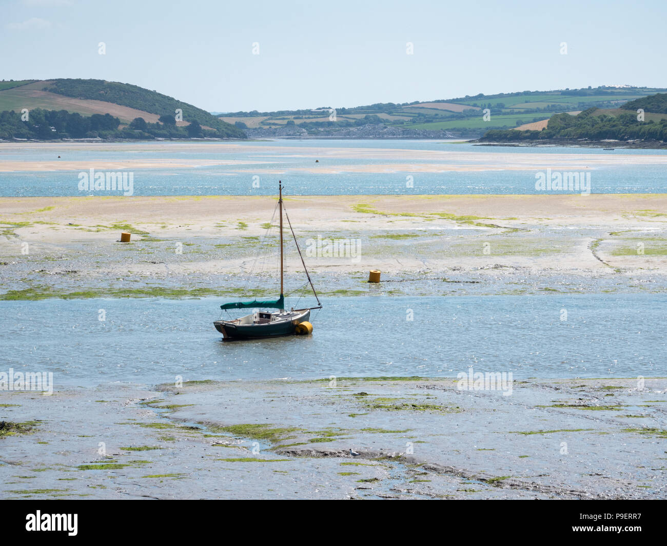 A sailing boat or yacht moored at low tide in the River Camel Estuary ...