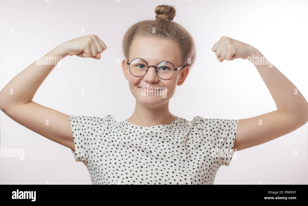 clever cheerful girl showing her muscles. develop muscles Stock Photo ...