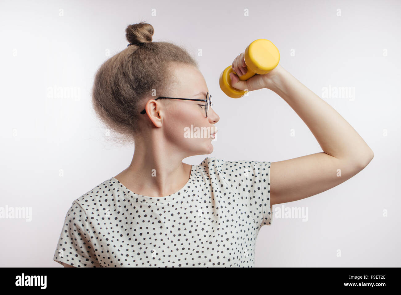 strong slim woman doing exercises with dumbbell. look at the arms ...