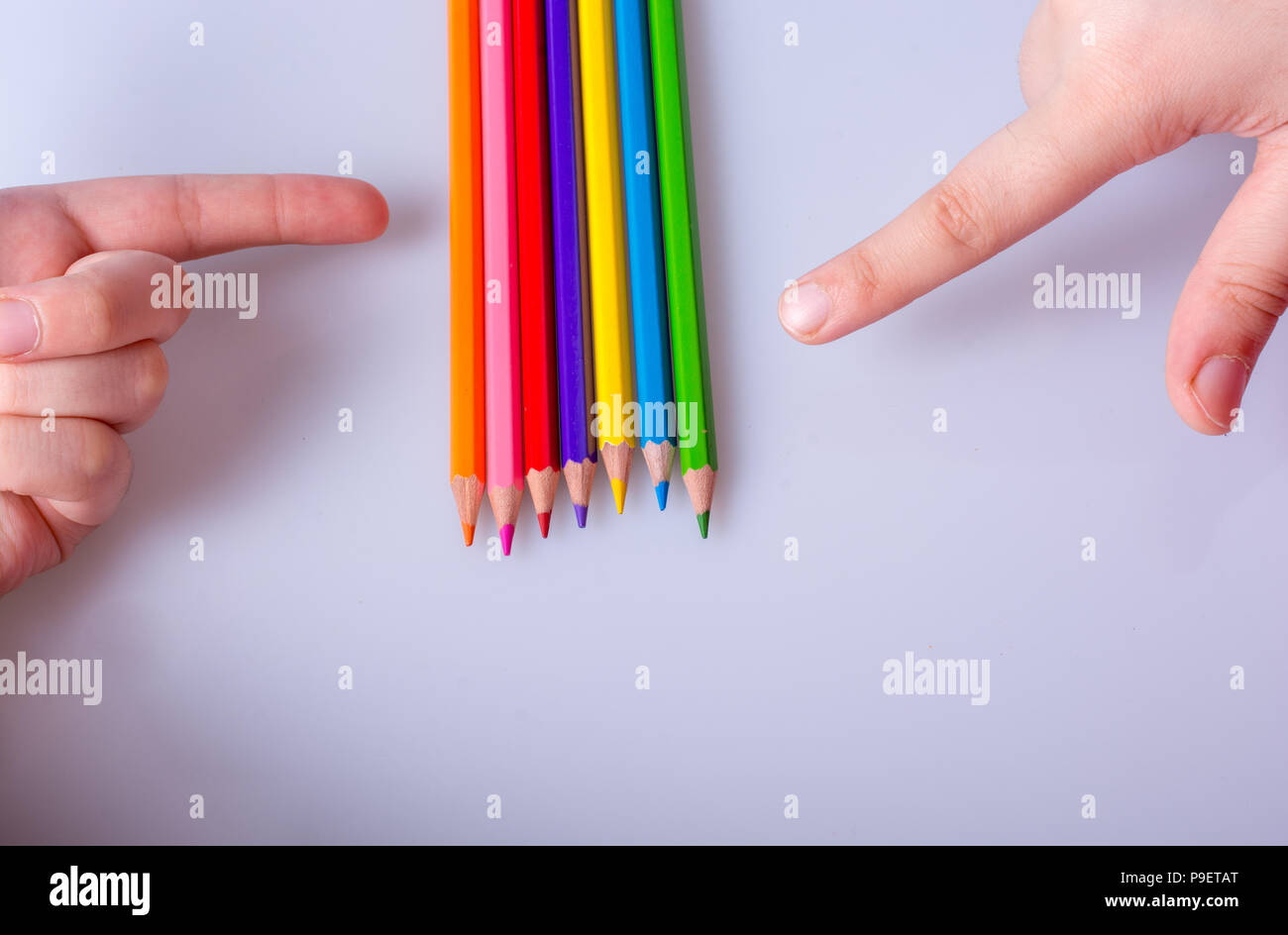 Hand holding color Pencils placed on a white background Stock Photo - Alamy