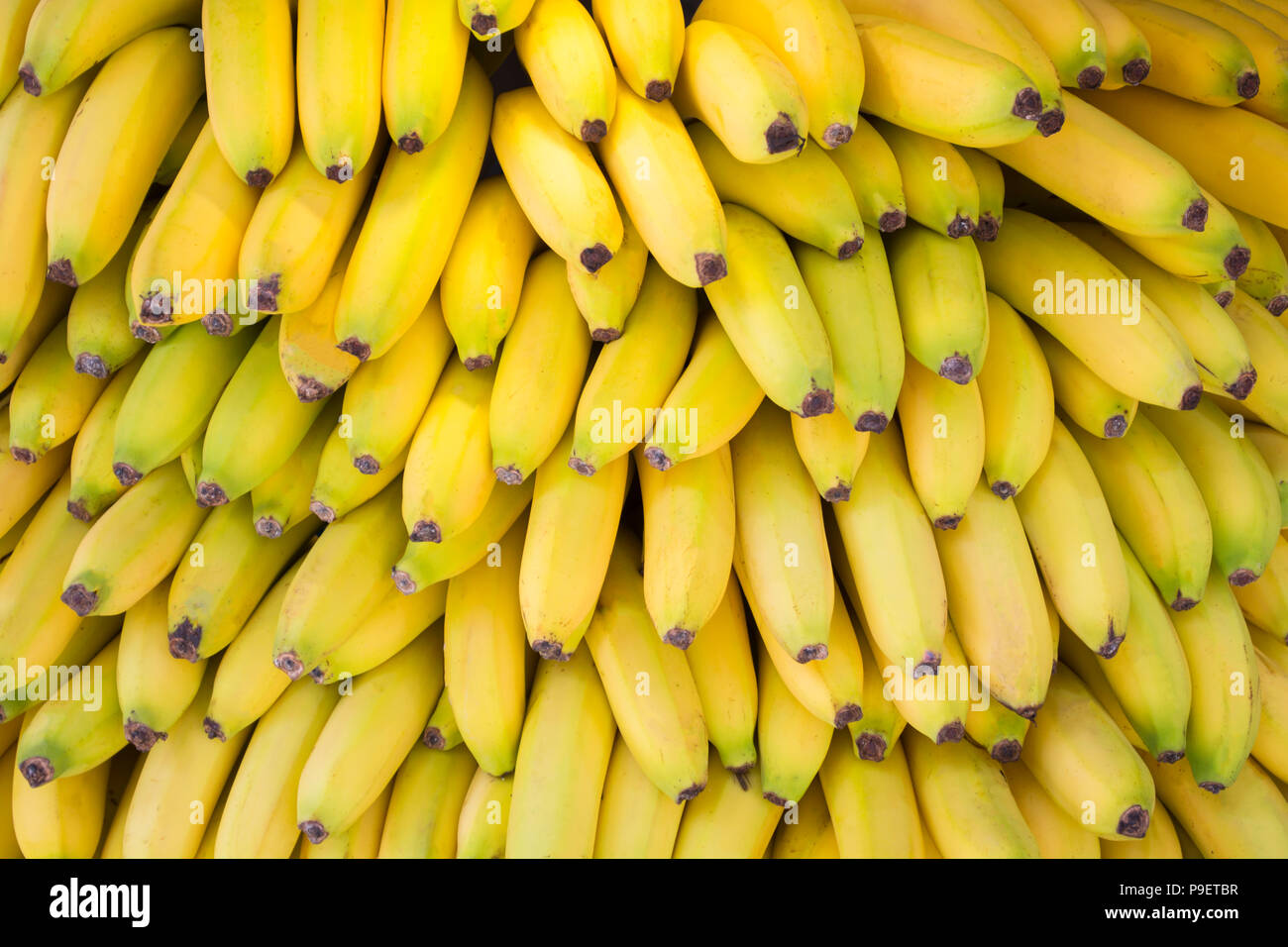 Fresh banana yellow background in the fruit market Stock Photo - Alamy