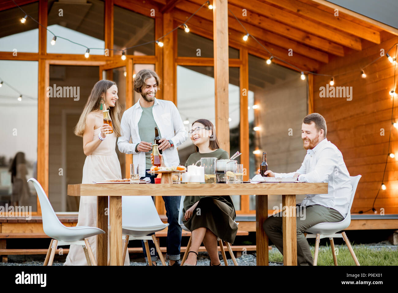 Friends family dinner on terrace hi-res stock photography and images ...