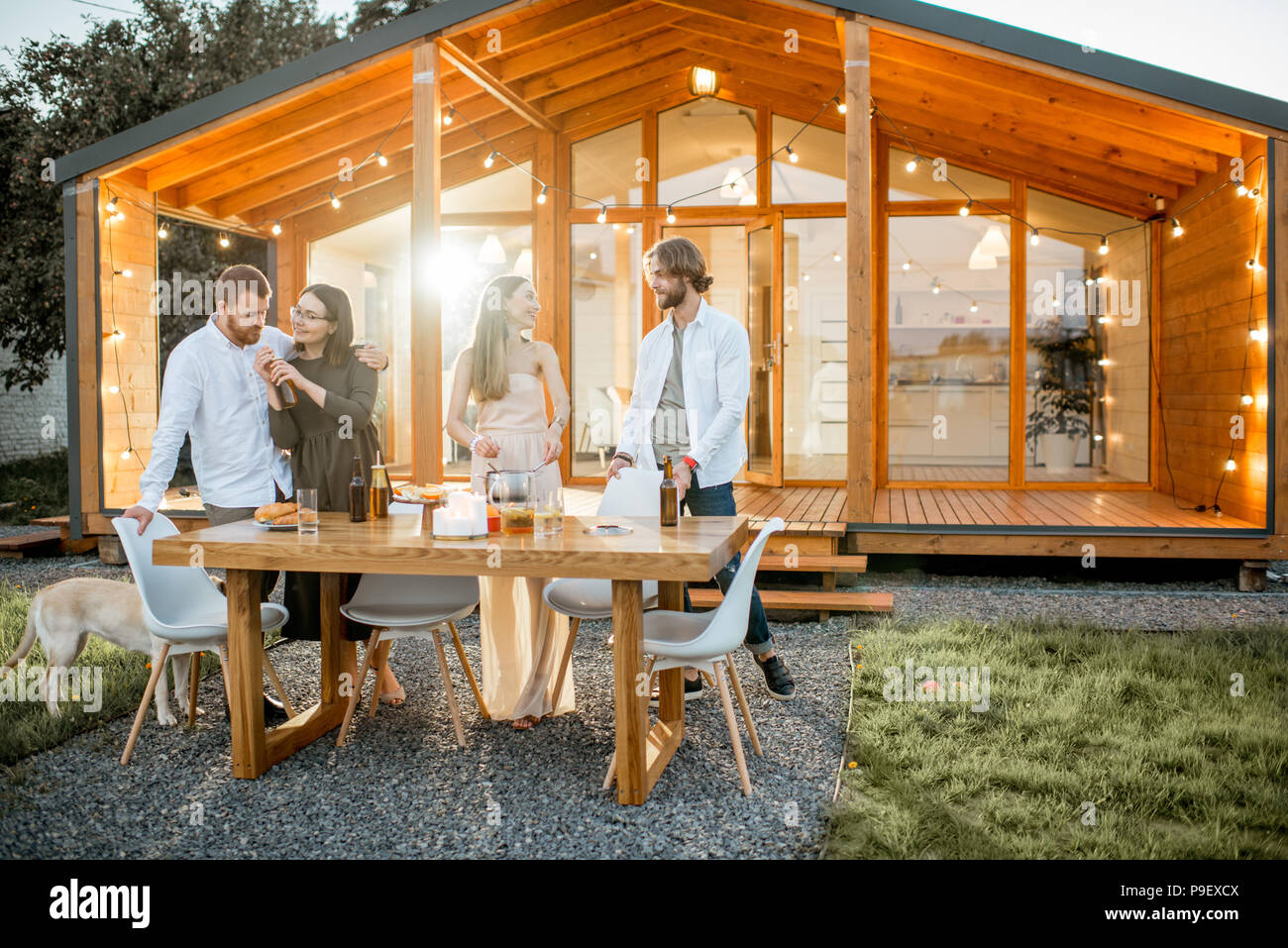 Friends having a snack on the backyard of the house Stock Photo - Alamy