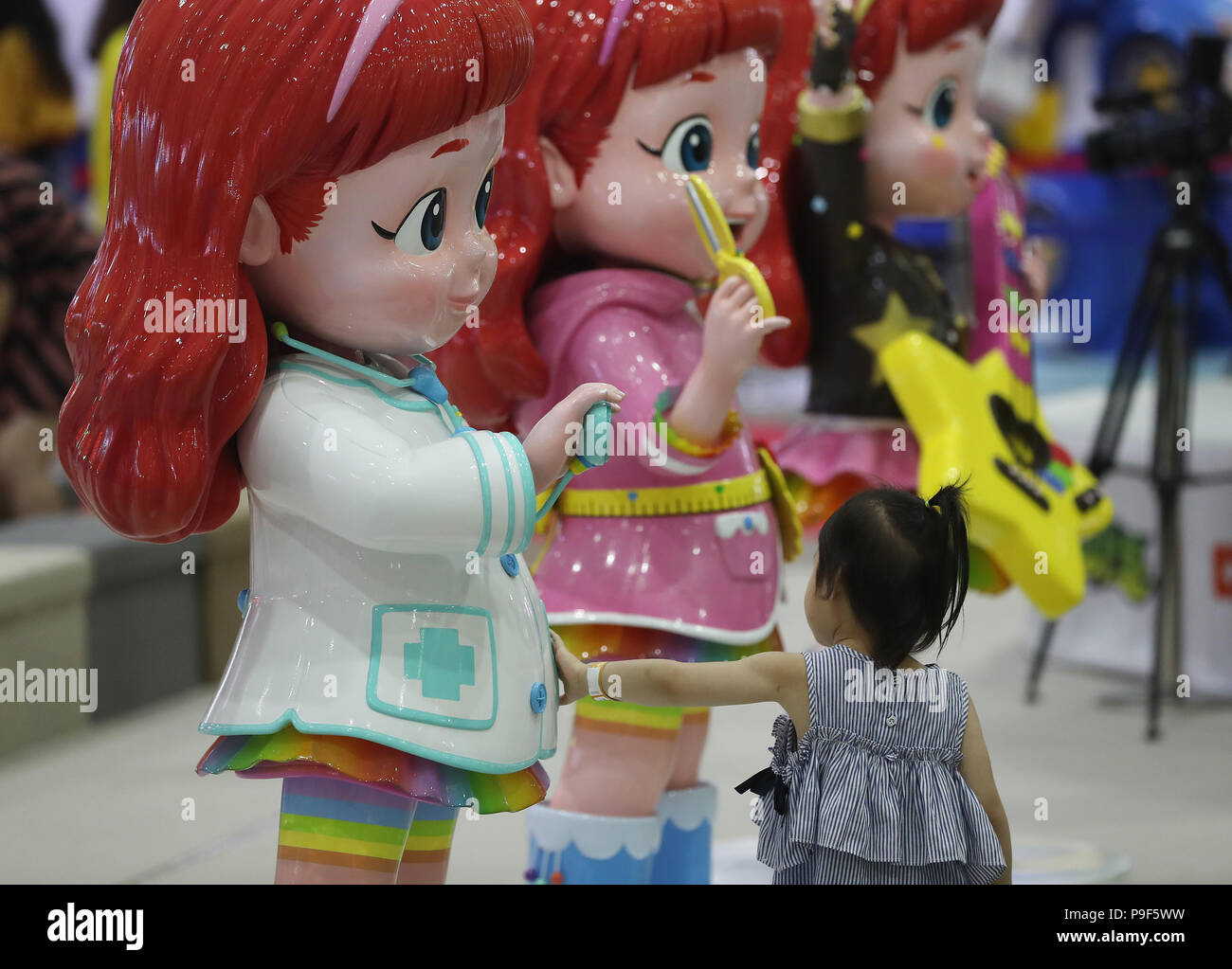 18th July, 2018. Character licensing fair A child stands beside ...