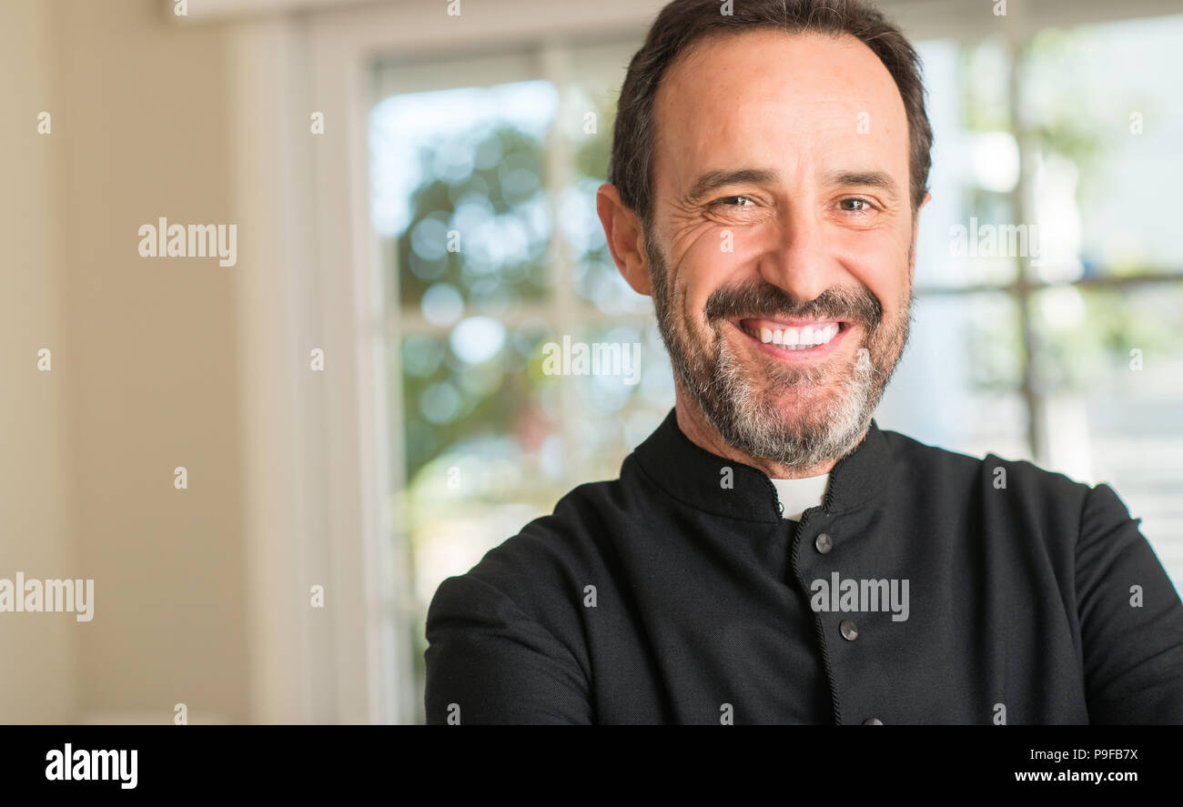 Christian priest man with a happy face standing and smiling with a ...