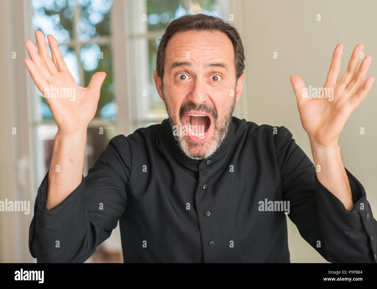 Christian priest man very happy and excited, winner expression ...