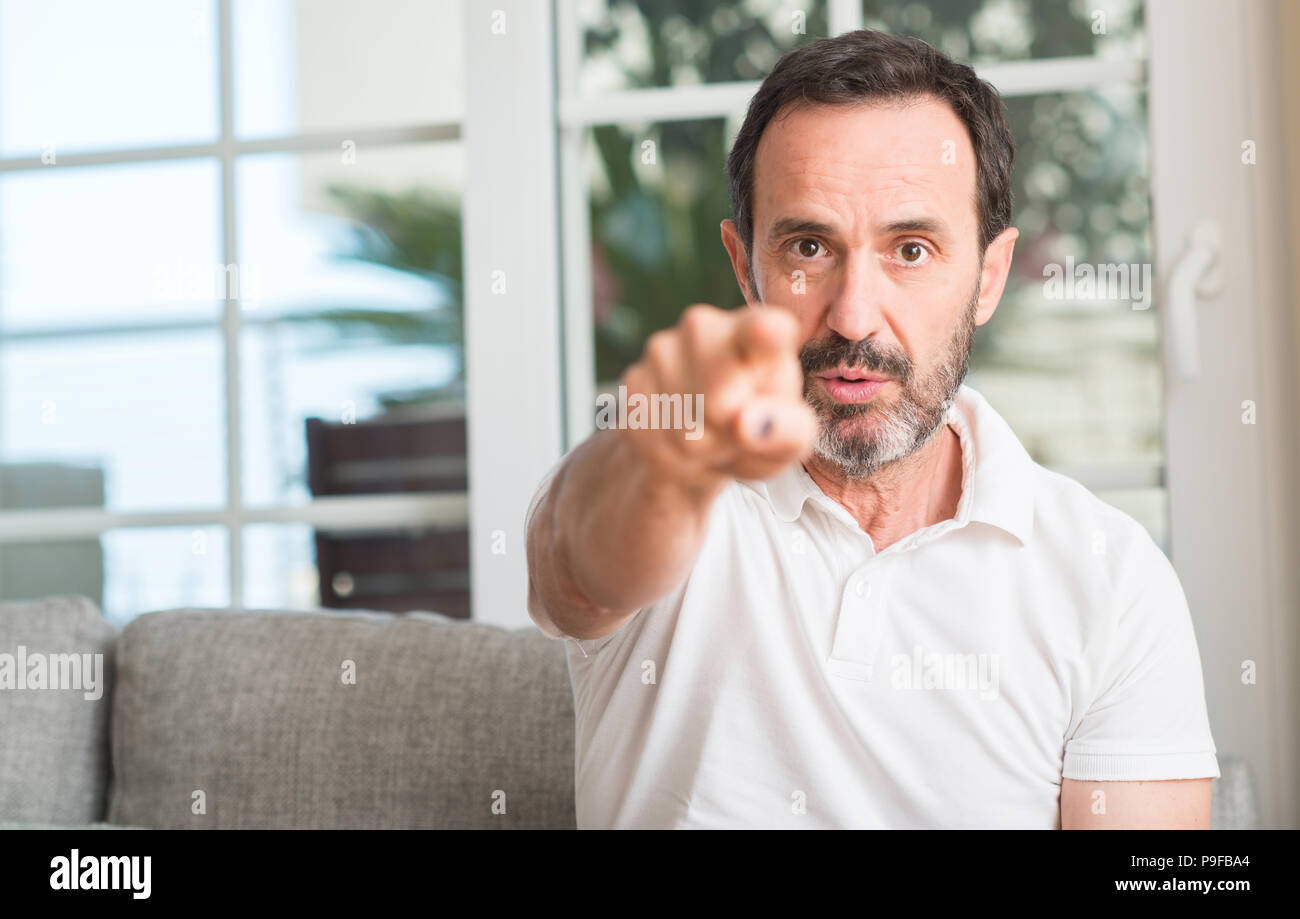 Handsome middle age man pointing with finger to the camera and to you ...
