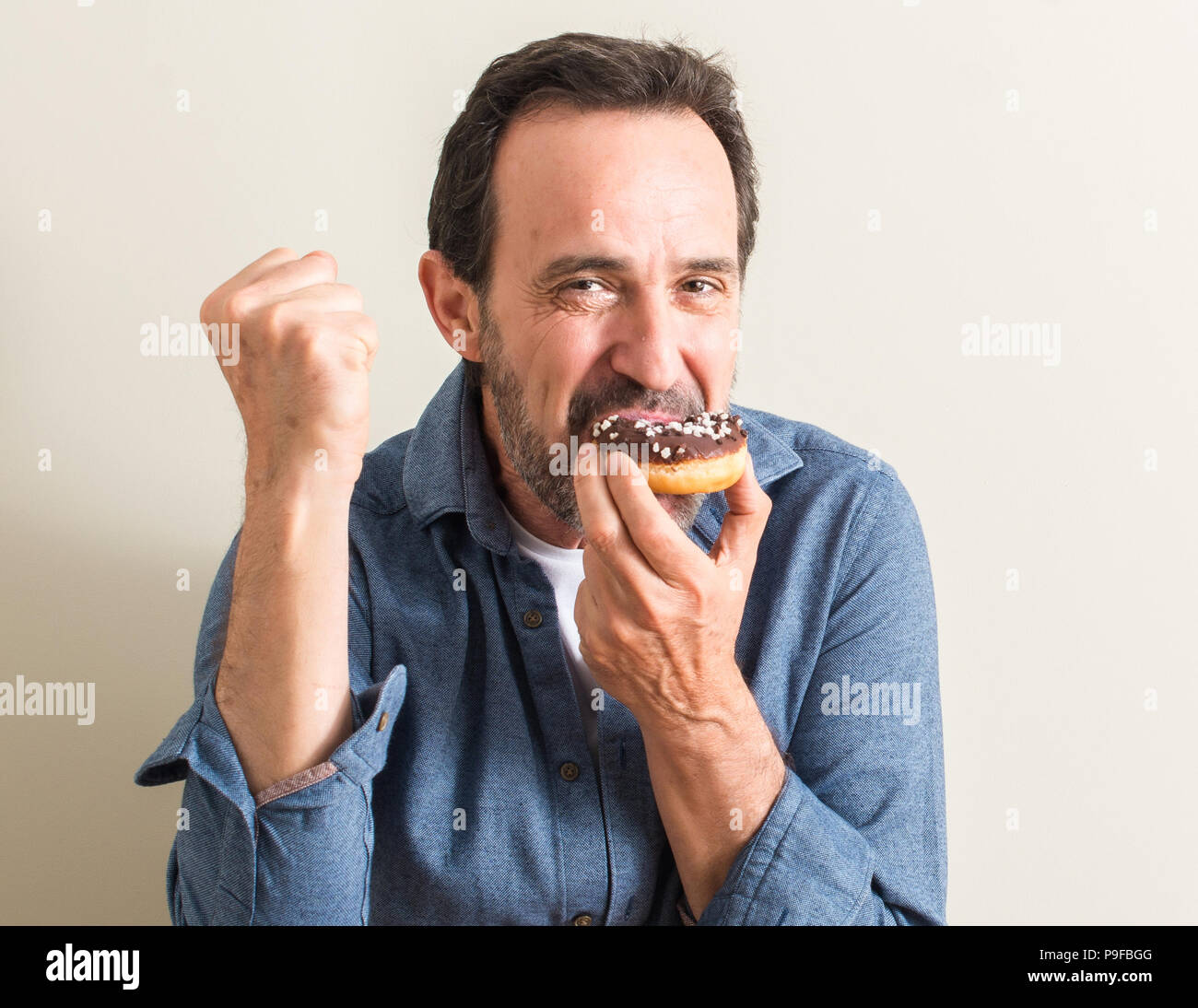 Senior man eating chocolate hi-res stock photography and images - Alamy