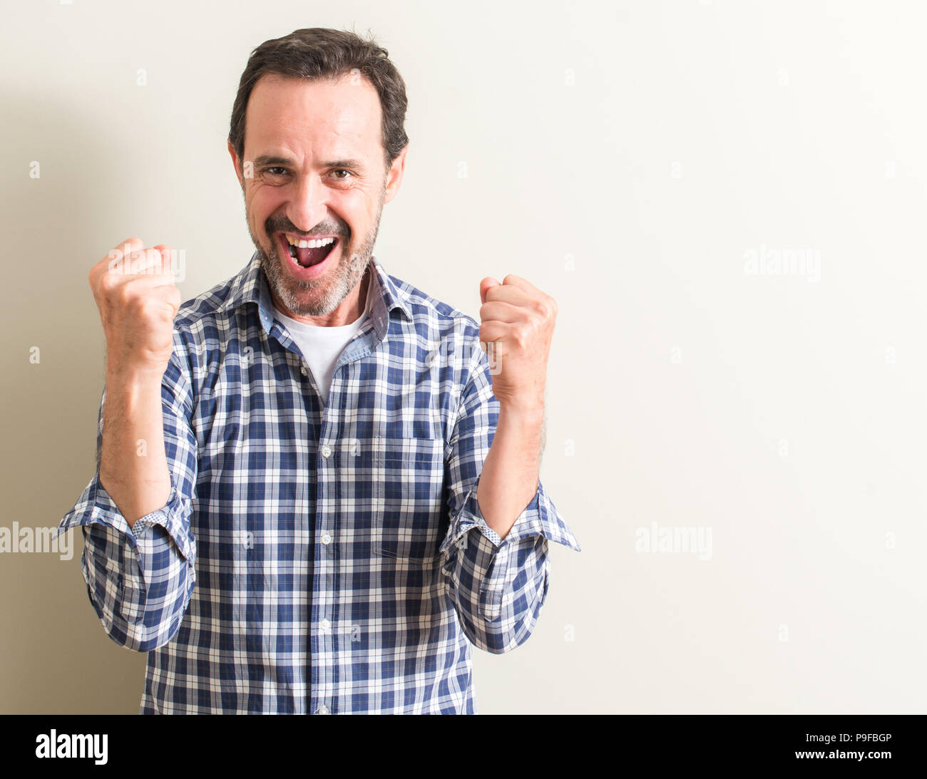Senior man screaming proud and celebrating victory and success very ...