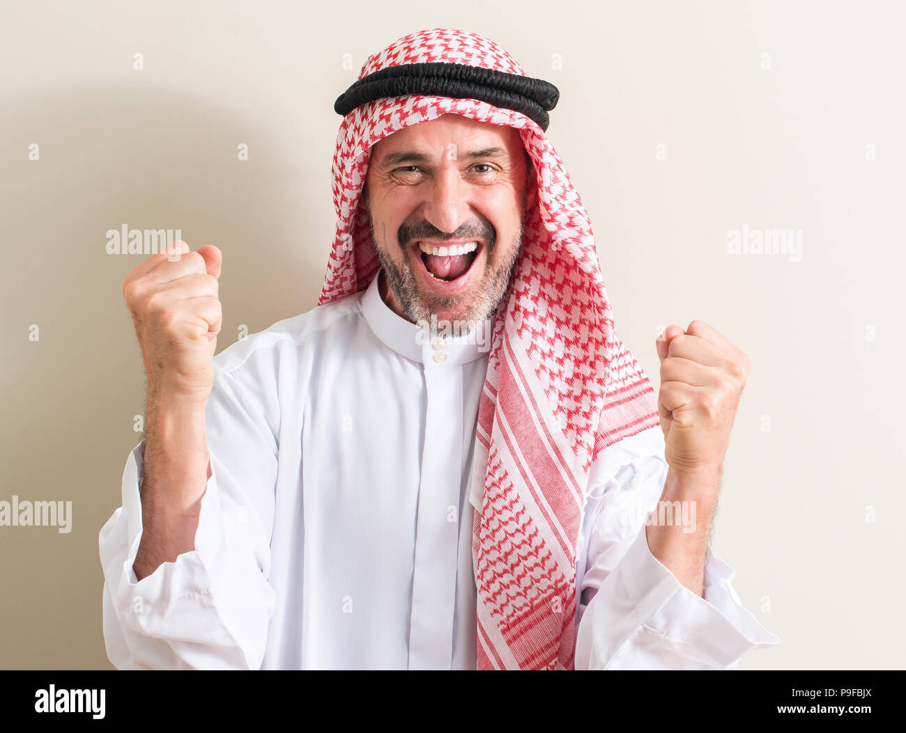 Senior arabic man screaming proud and celebrating victory and success ...