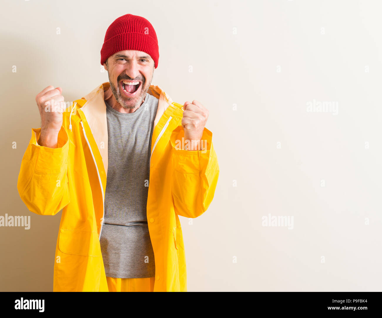 Senior fisherman screaming proud and celebrating victory and success ...