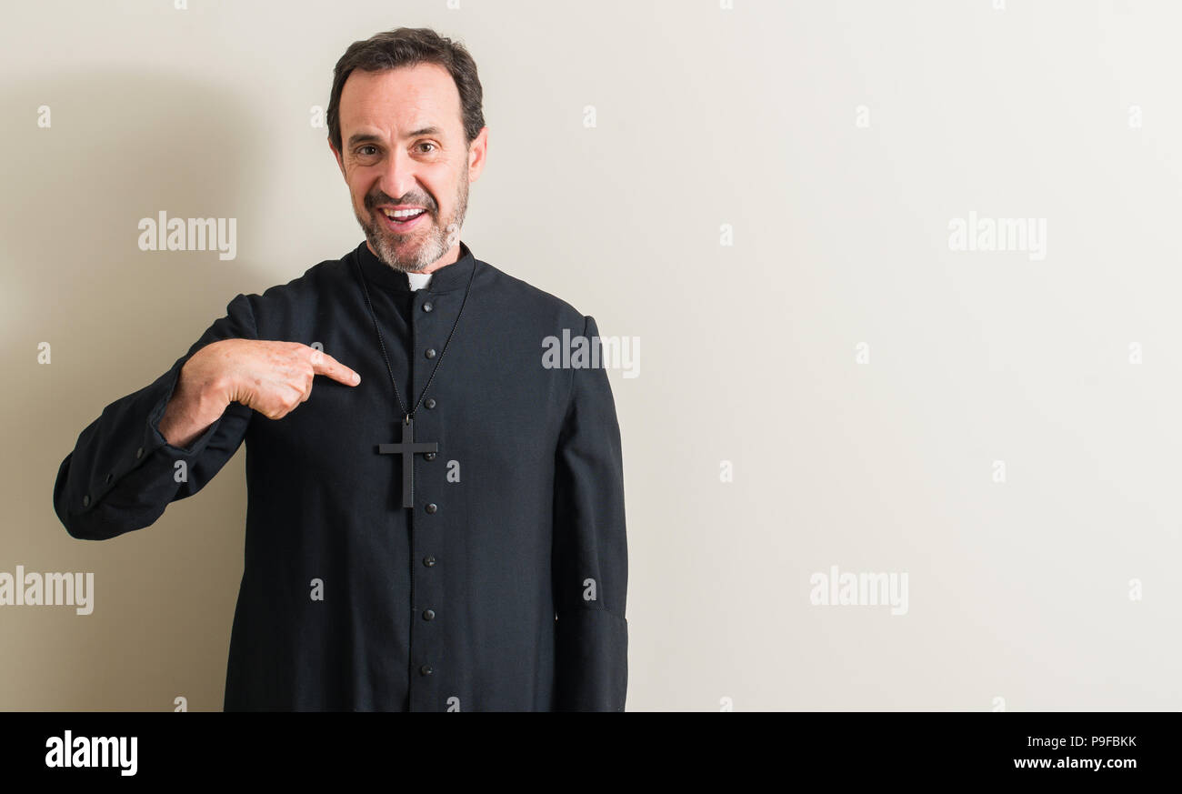 Senior priest religion man with surprise face pointing finger to ...