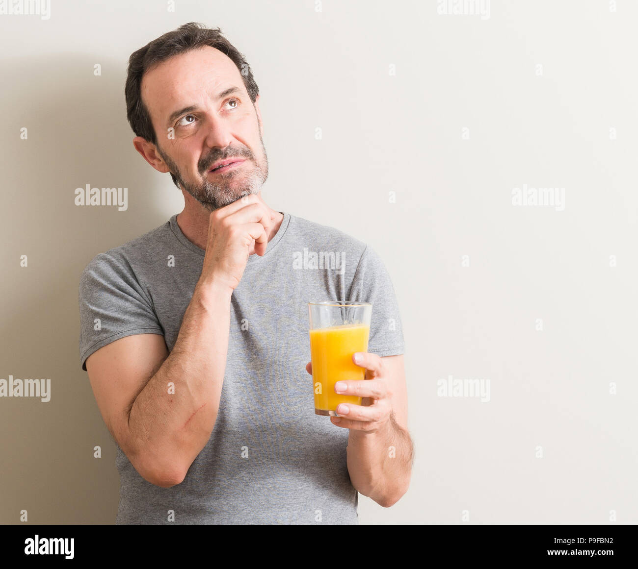 Senior man drinking orange juice hi-res stock photography and images ...
