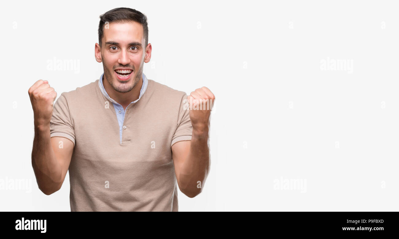 Handsome young man screaming proud and celebrating victory and success ...