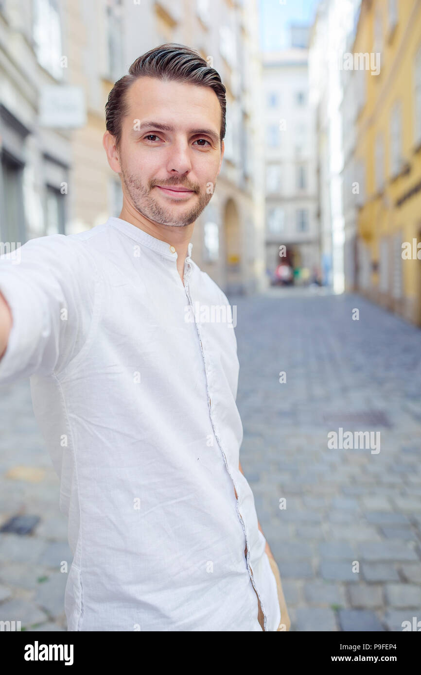 Young man background the old european city take selfie Stock Photo - Alamy