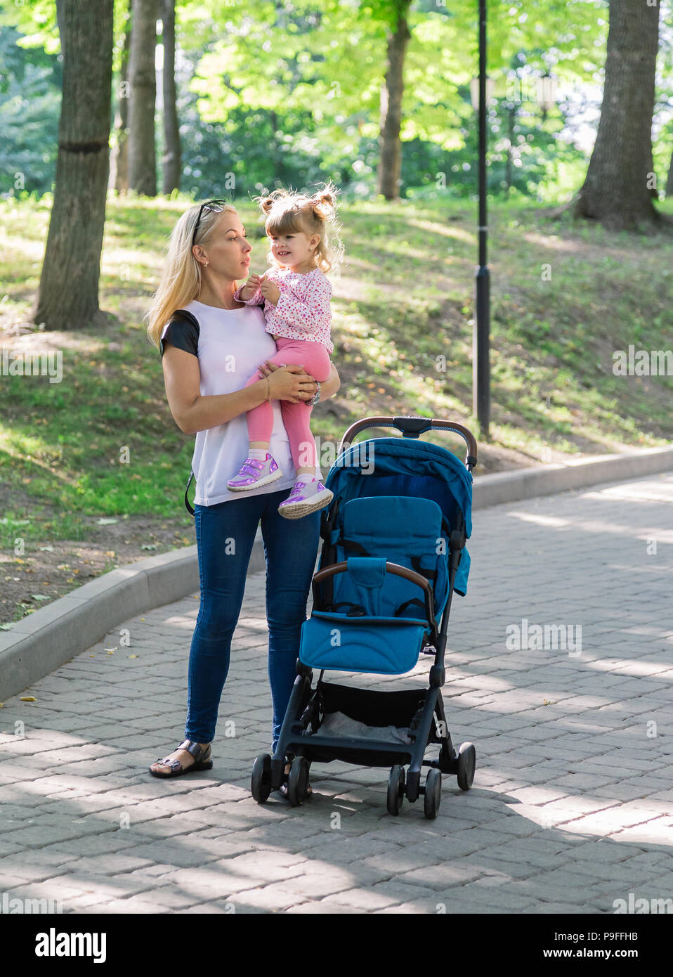 Shopping woman pushing stroller hi-res stock photography and images - Alamy