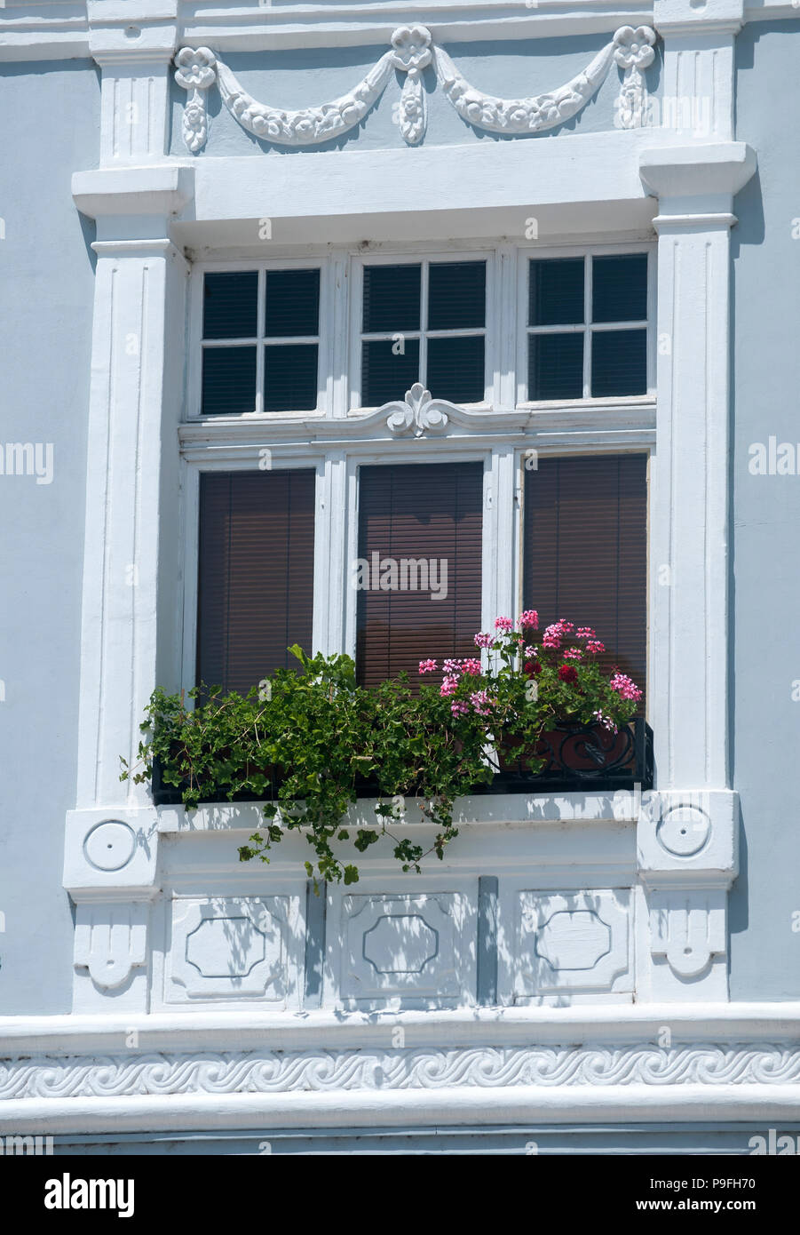 Window of old retro blue painted ornamented house facade closeup in ...