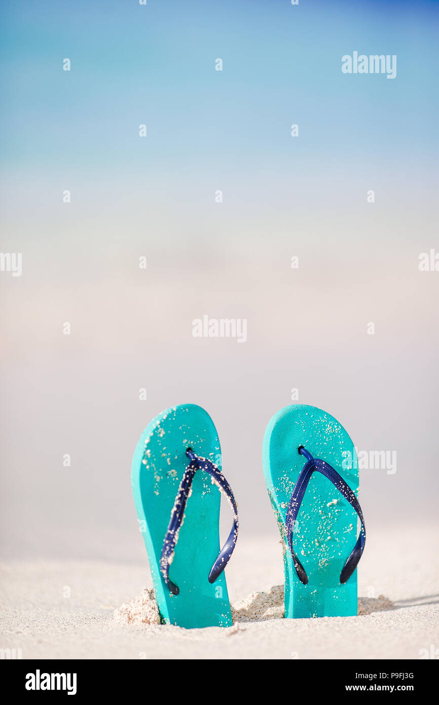Summer mint flip flops with sunglasses on white beach Stock Photo - Alamy