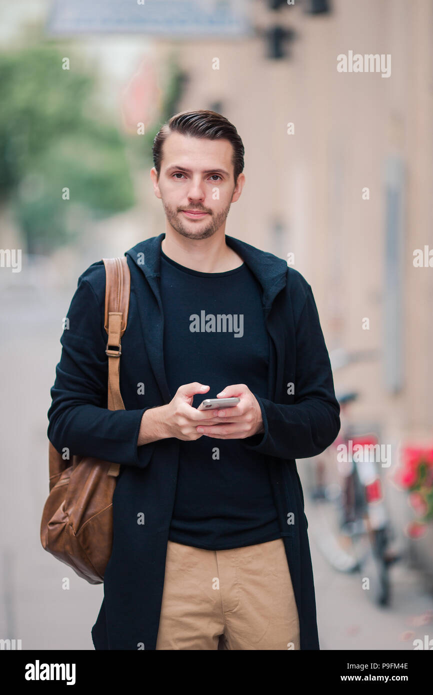Man tourist with a city map and backpack in Europe street. Caucasian ...