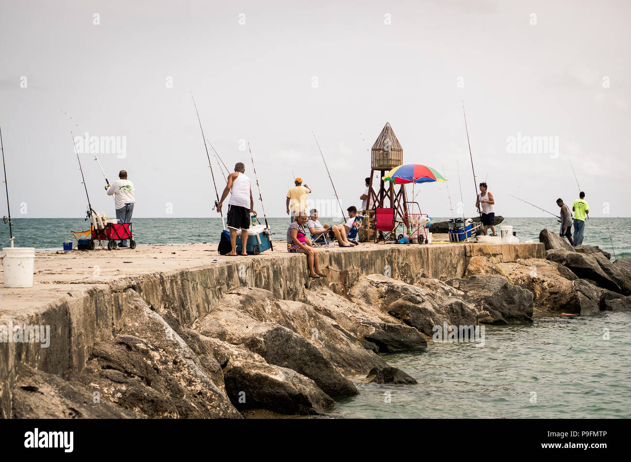 People fishing on a jetty Stock Photo - Alamy