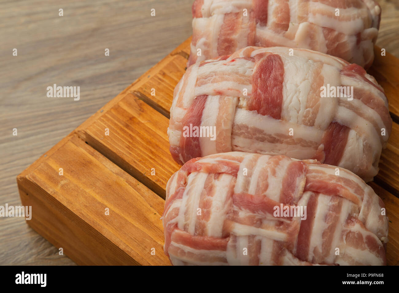 Semi-finished meat, seasoned on a wooden background Stock Photo - Alamy