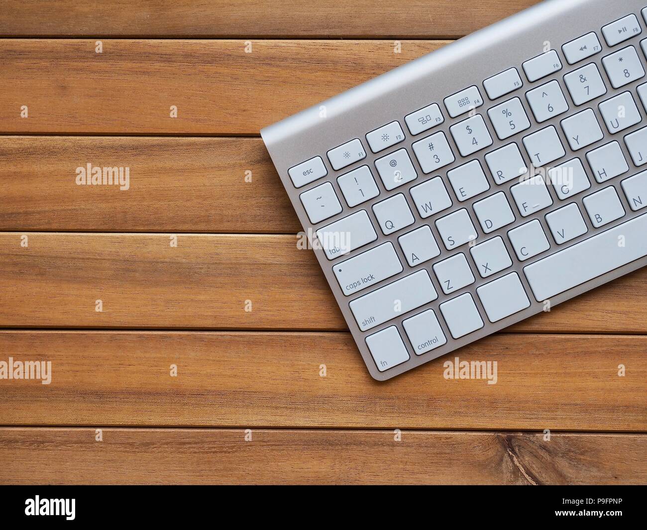Wooden board with white keyboard Stock Photo - Alamy