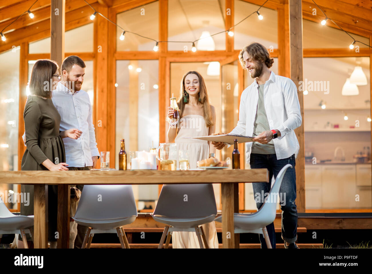 Family friends eating pizza hi-res stock photography and images - Alamy