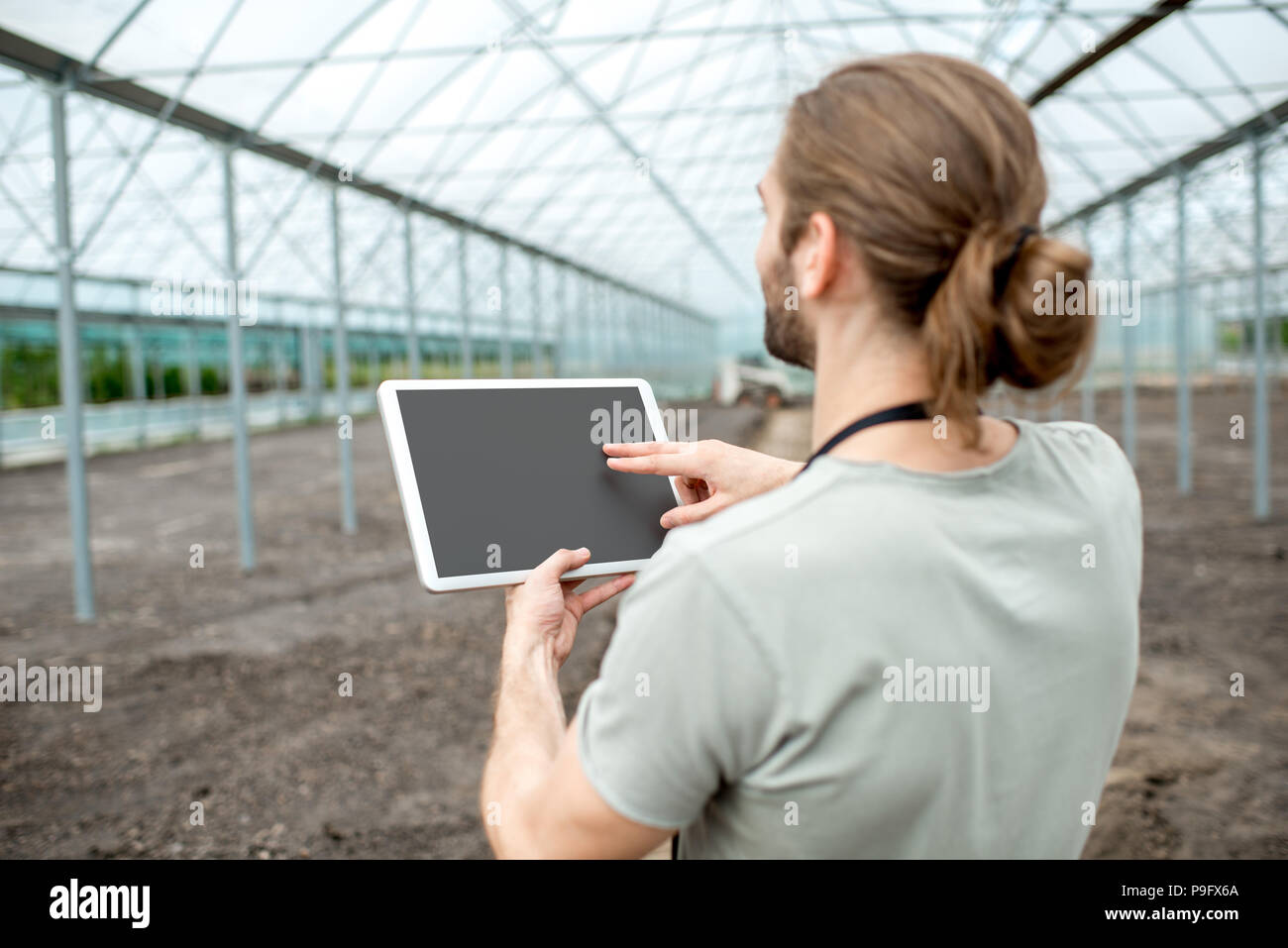 Farmer with tablet in the glasshouse Stock Photo - Alamy