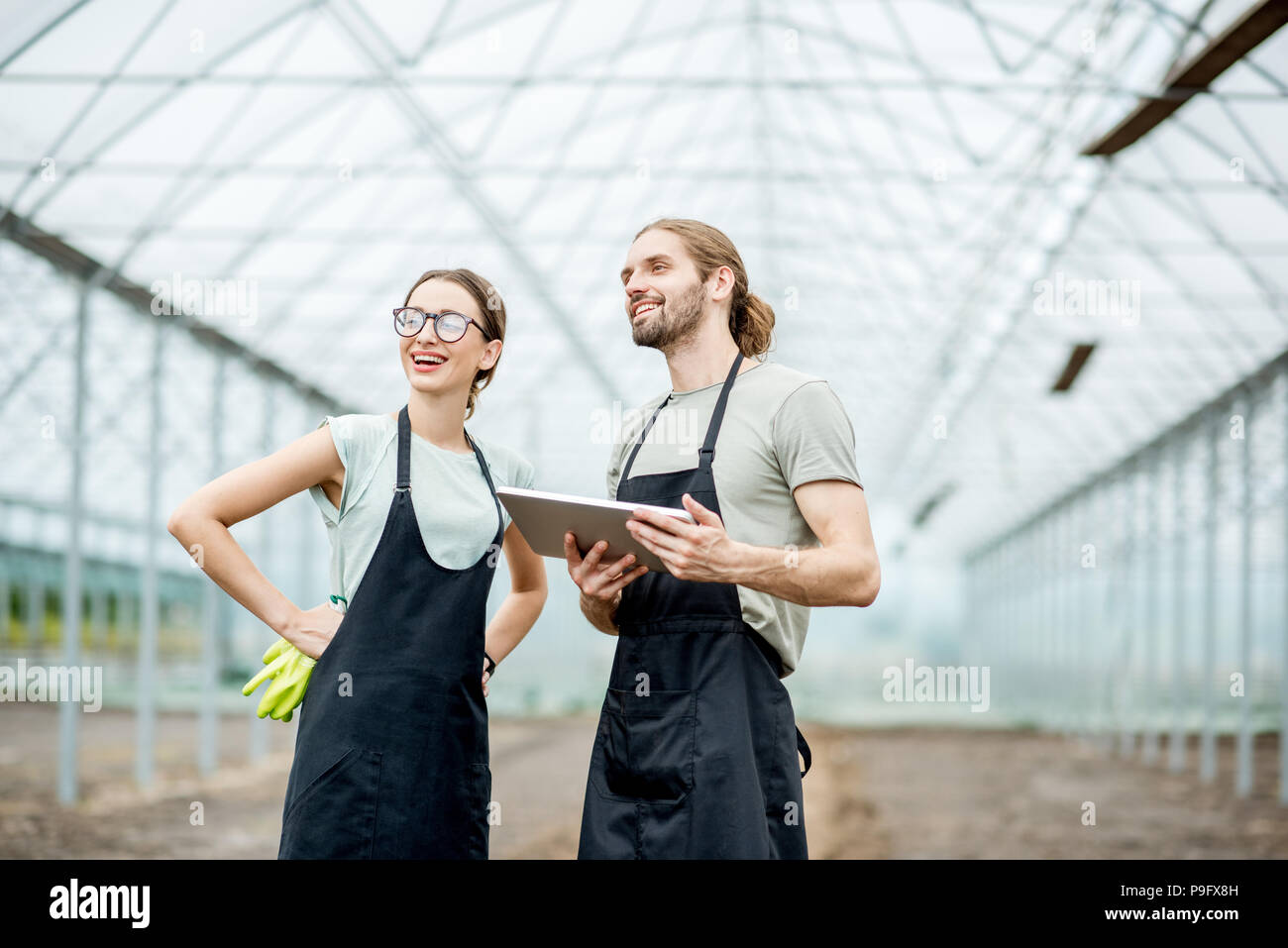 Farmers with tablet in the glasshouse Stock Photo - Alamy