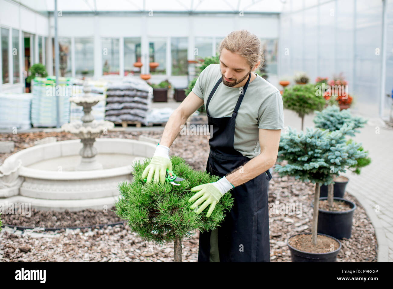 Gardener working in the garden Stock Photo - Alamy