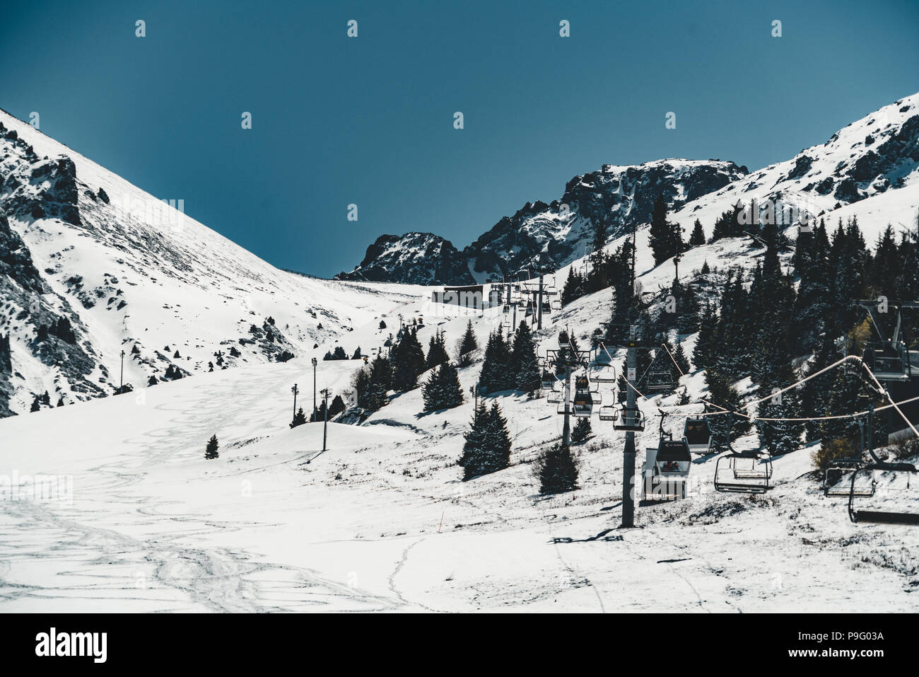 Ski lift in Almaty mountains. Shymbulak Ski Resort Hotel now-capped ...
