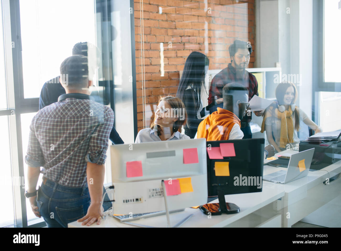 multy ethnic journalists are gathered together in the modern office ...