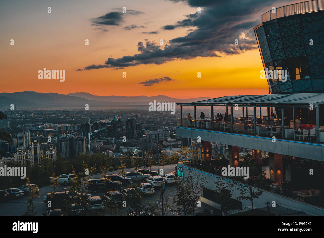Sunset over the city of Almaty and a view of the Kok Tobe TV Tower ...