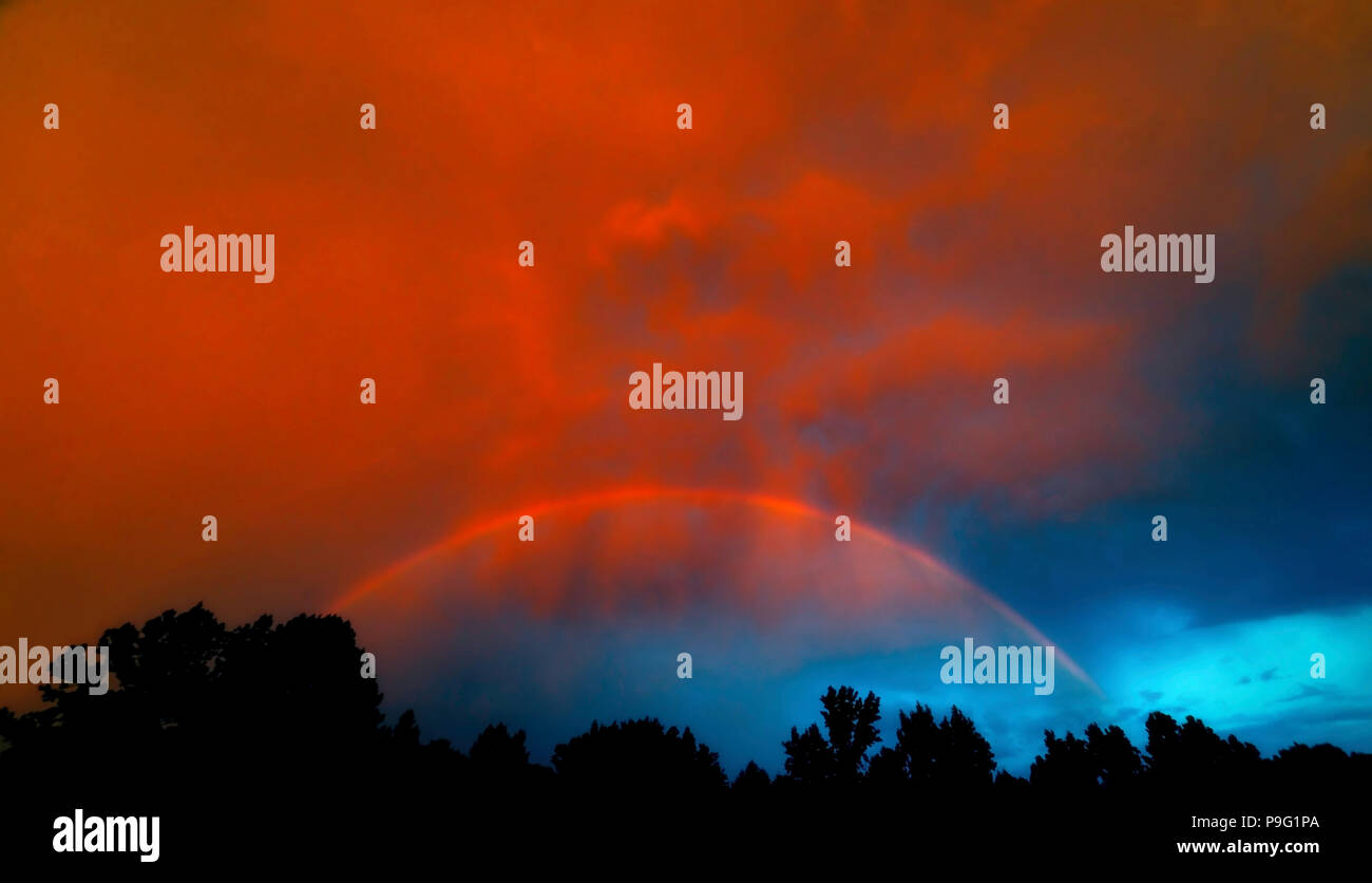 Storm clouds clearing, sun setting and a rainbow all at once. God is ...