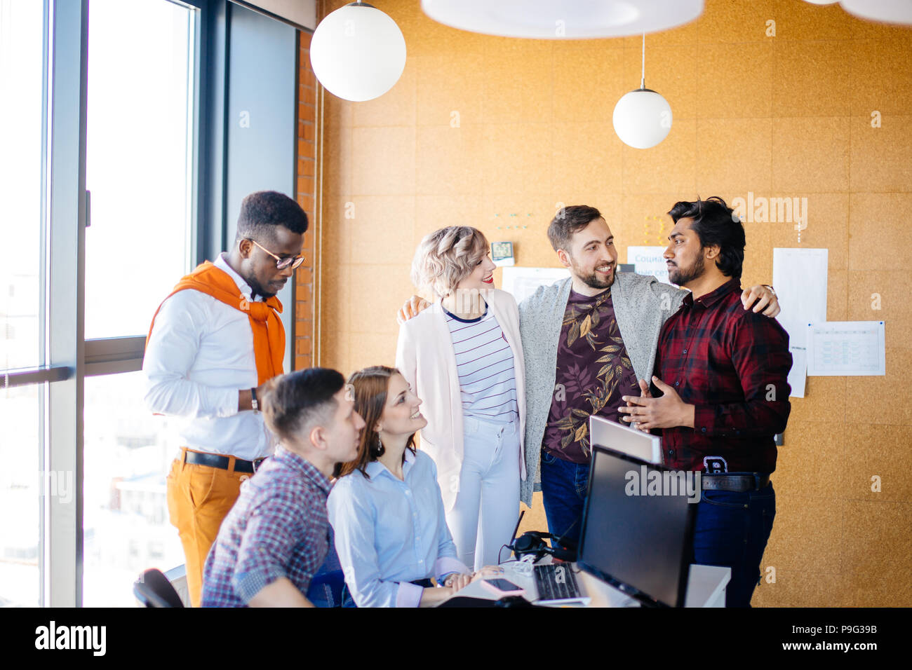 friendship among colleagues concept. hugging co-workers are discussing ...