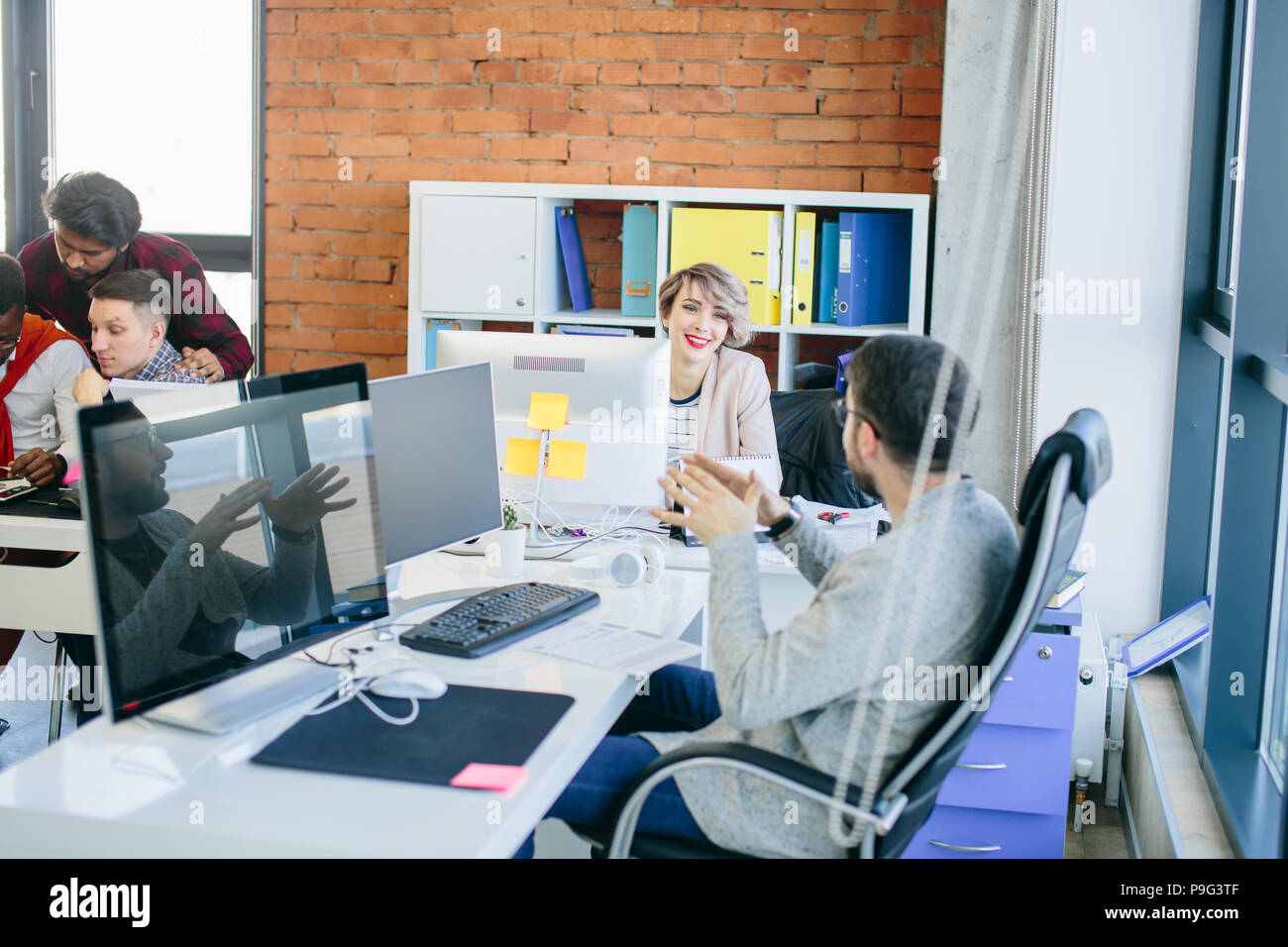 young good-looking team members discussing business ideas in loft ...