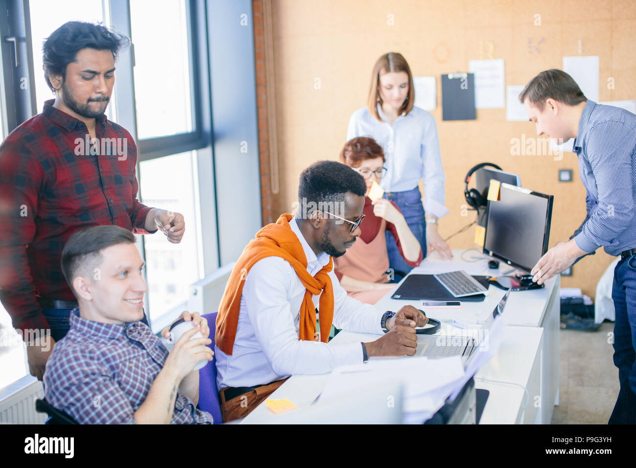 young African operator trying to concentrate on his work in the loft ...