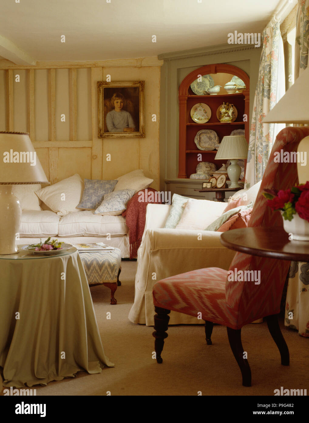 Cream sofas in small cream cottage living room Stock Photo - Alamy