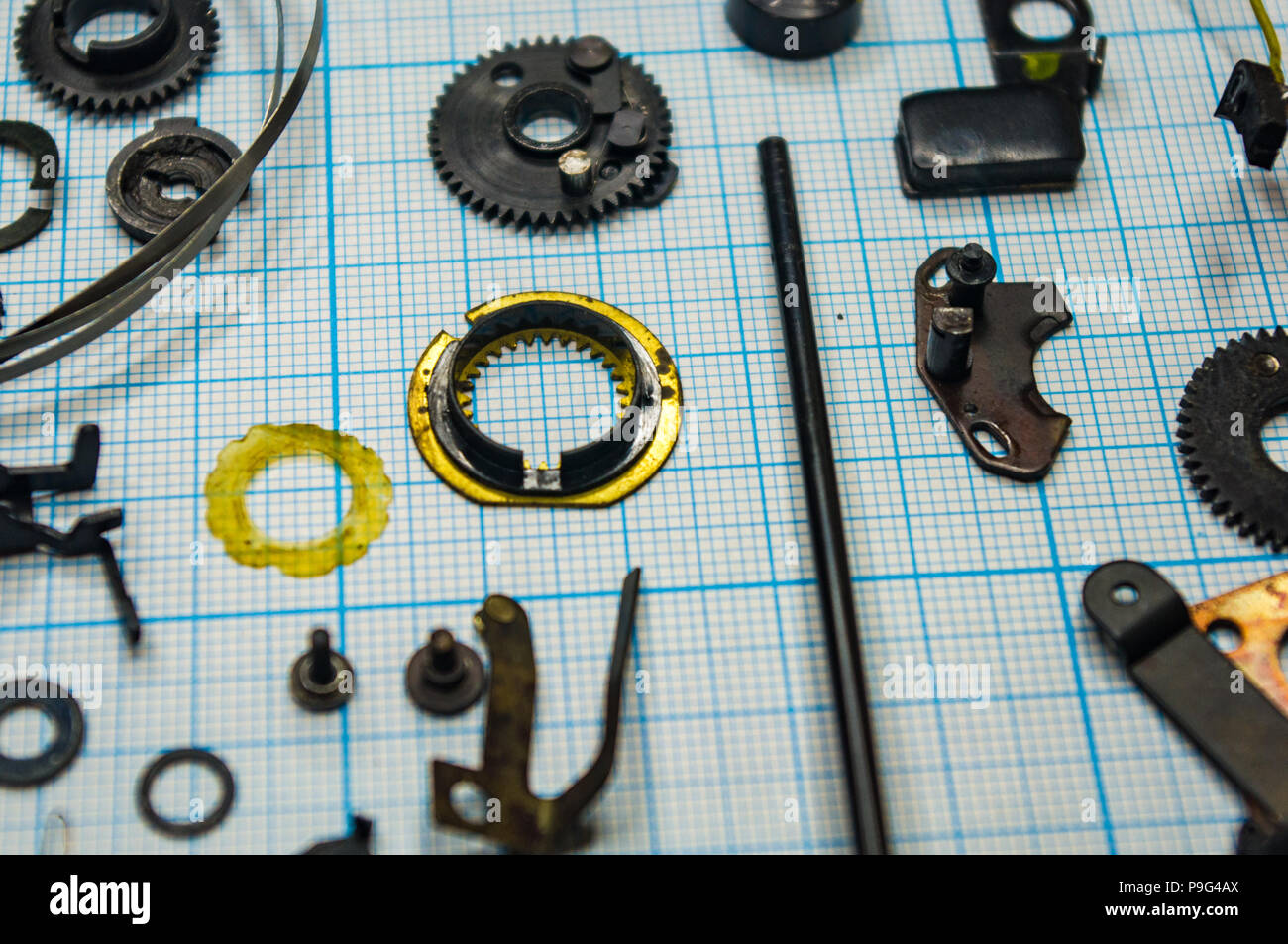 parts are completely disassembled old retro film SLR camera on graph ...