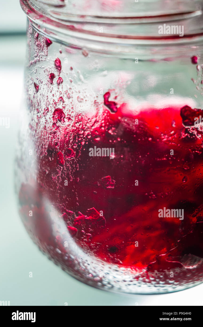 Bright translucent red currant jam in a glass jar, close-up, macro ...