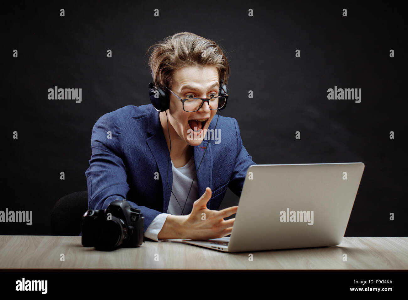 screaming young man in blue suit has won the online game. happiness ...