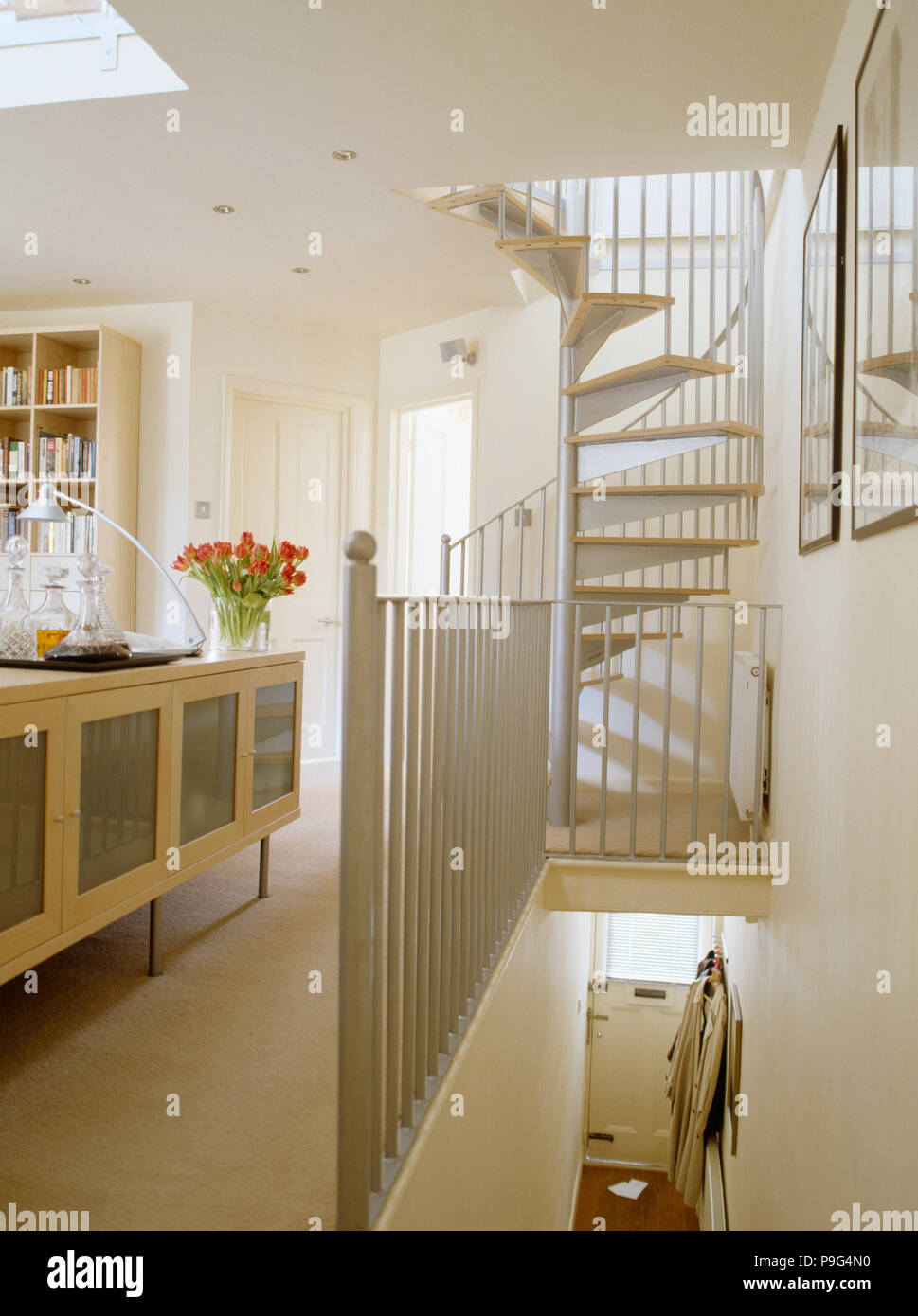 Spiral staircase from modern living room and white landing Stock Photo ...
