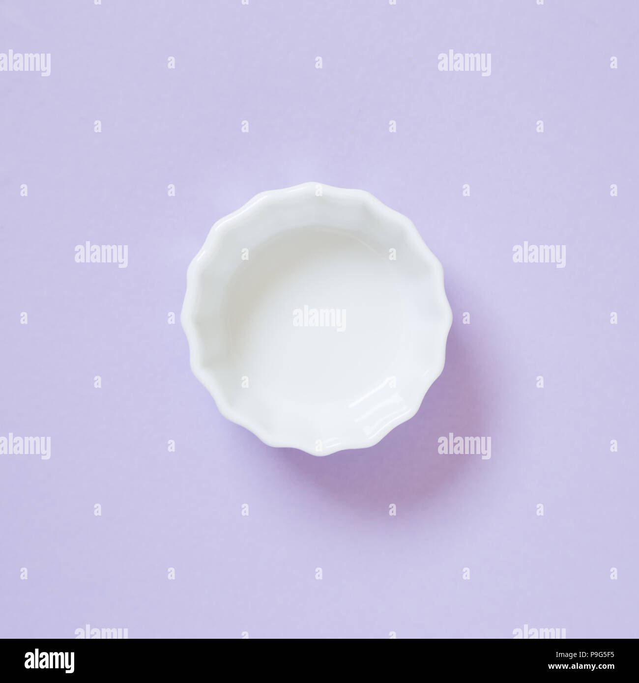 White dish isolated on purple background Stock Photo - Alamy