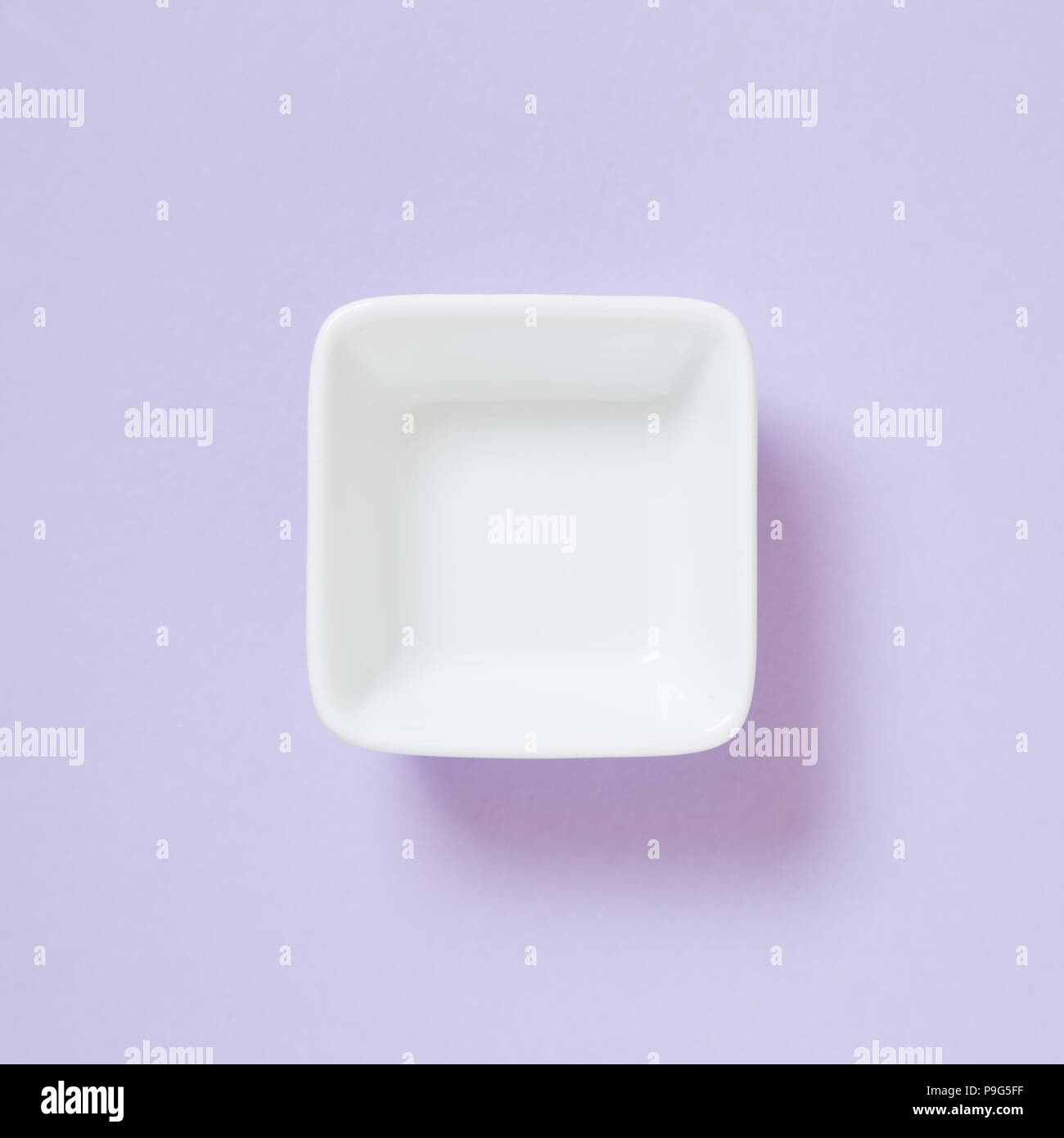 White dish isolated on purple background Stock Photo - Alamy