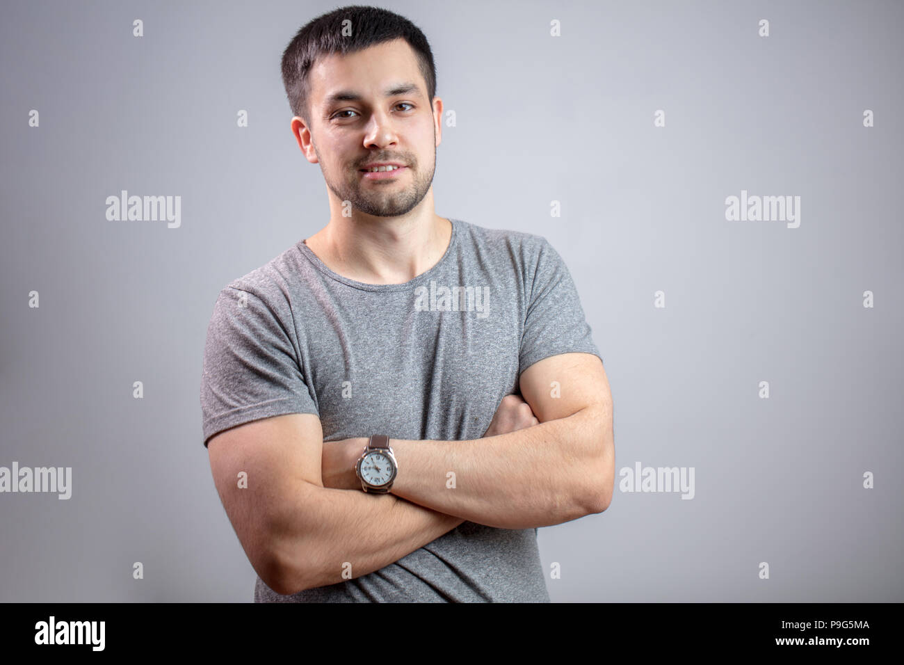 Portrait of young strong man with crossed arms.bodyguard in casual ...